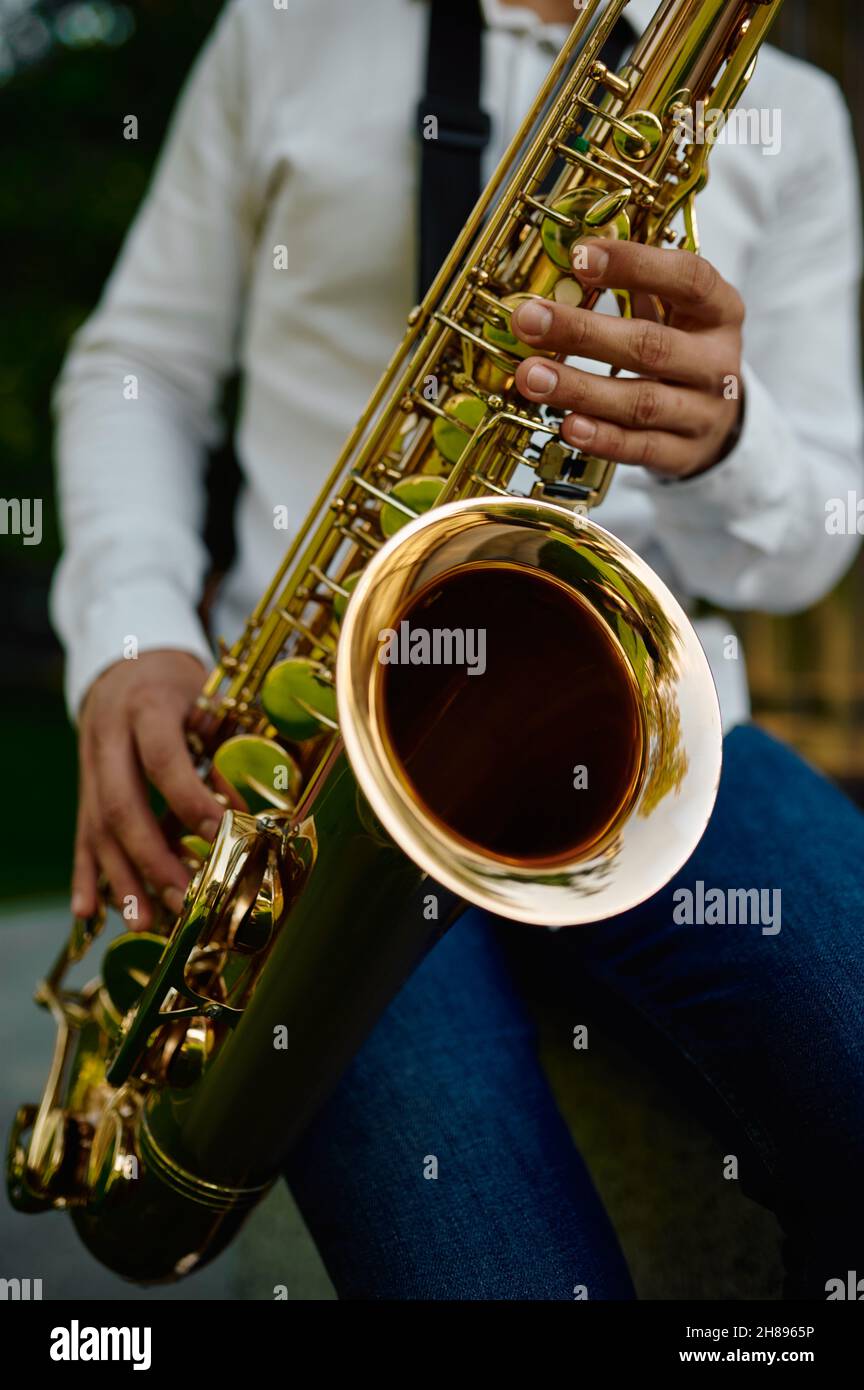 Male saxophonist plays the saxophone in park Stock Photo - Alamy