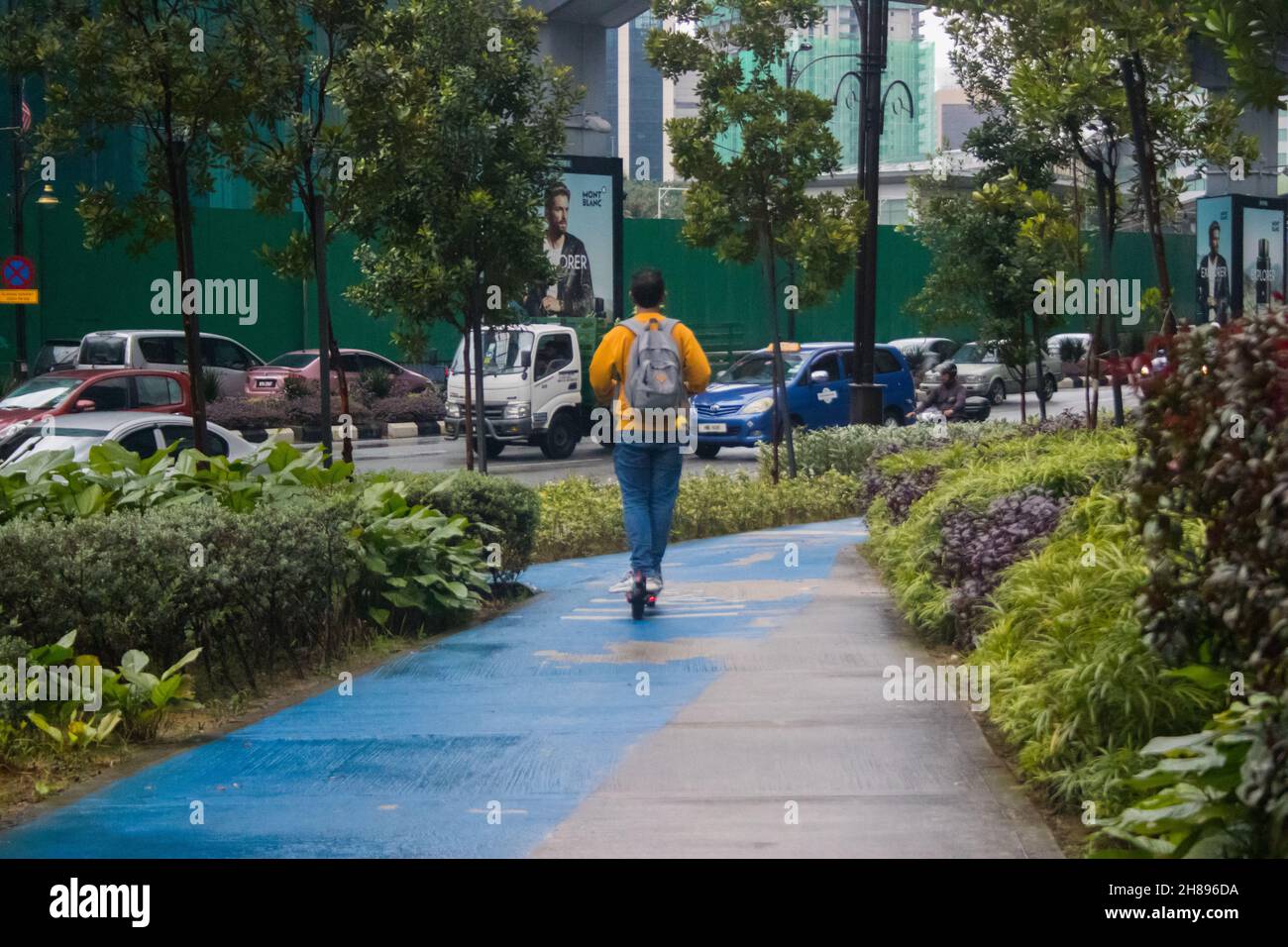 A man riding a Beam electronic scooter in Kuala Lumpur City Centre ...