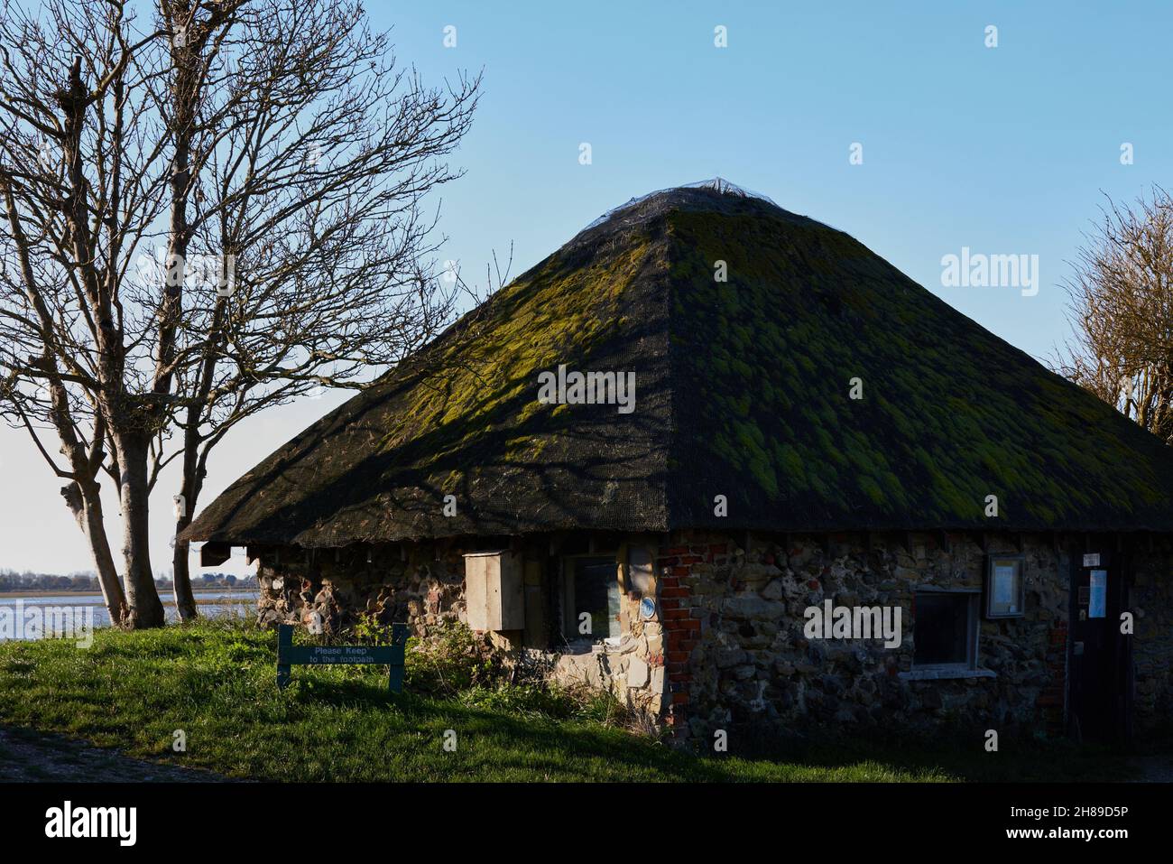 Small thatched cottage seen in Pagham Harbour Nature Reserve Stock ...