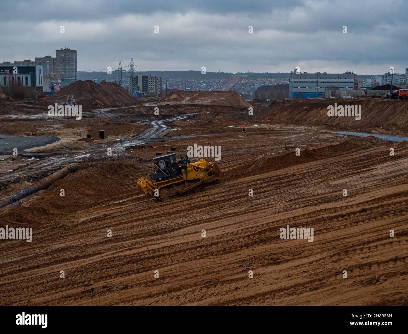 Bulldozer on the construction of a new road. Highway construction site ...