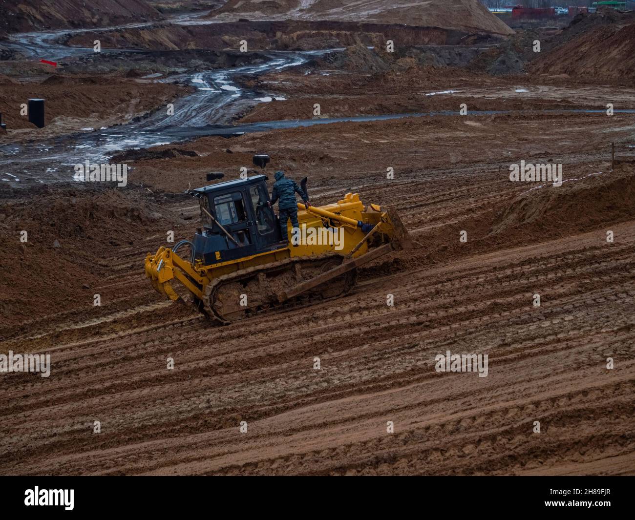 Bulldozer on the construction of a new road. Highway construction site ...