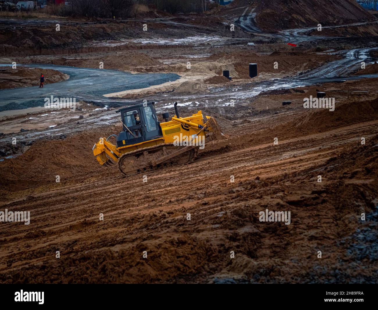 Bulldozer on the construction of a new road. Highway construction site ...