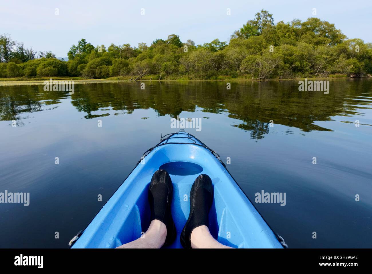 Blue kayak in Loch Lomond on open water Stock Photo - Alamy