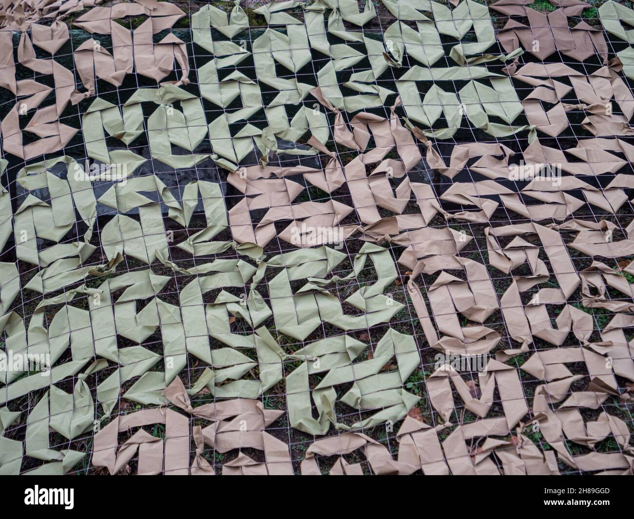 Camouflaged military screening netting at the army camp. Checkpoint ...