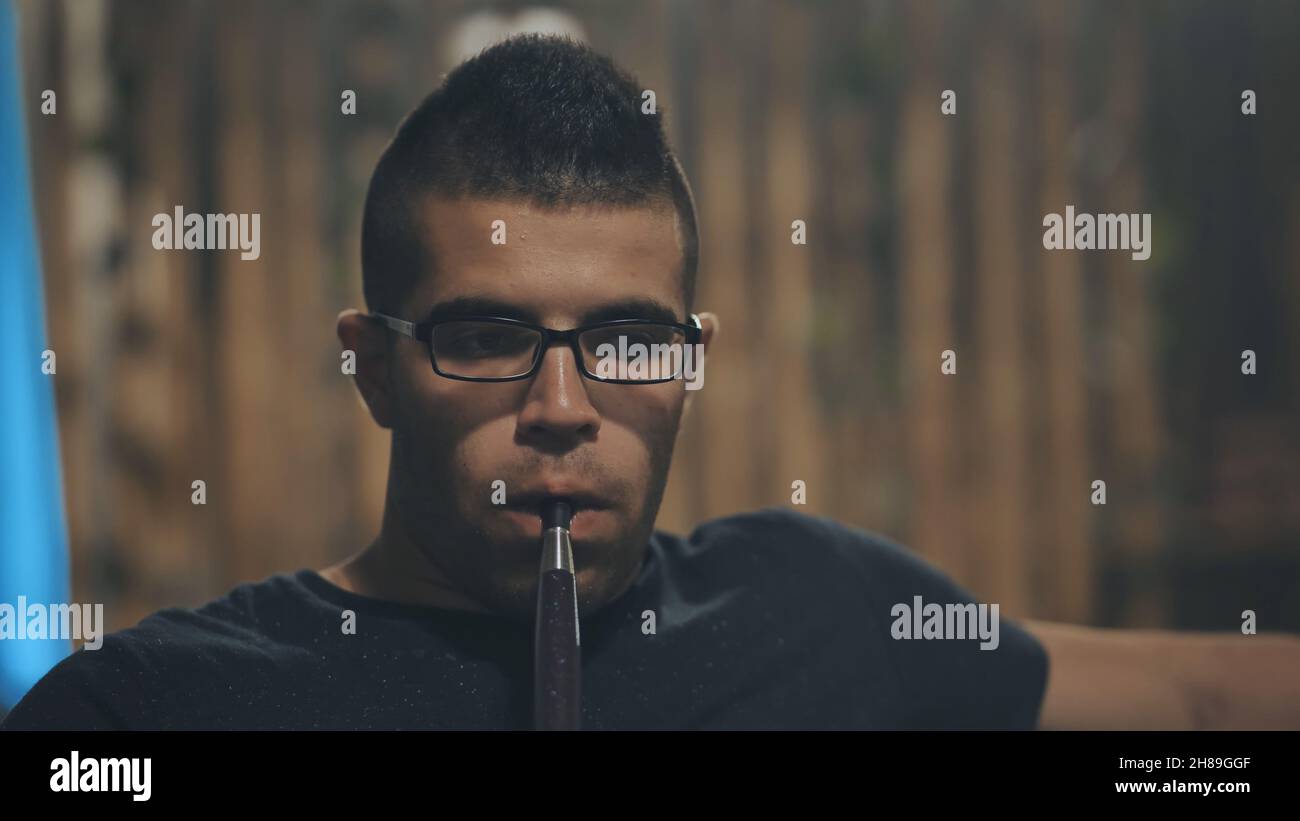 Arabic jordanian young man smokes a hookah Stock Photo - Alamy