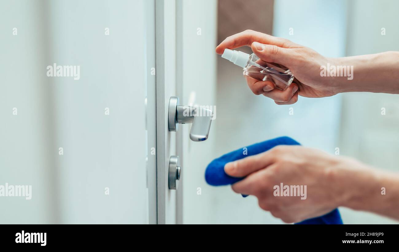 close up. man spraying antiseptic spray on the door handle. photo with ...
