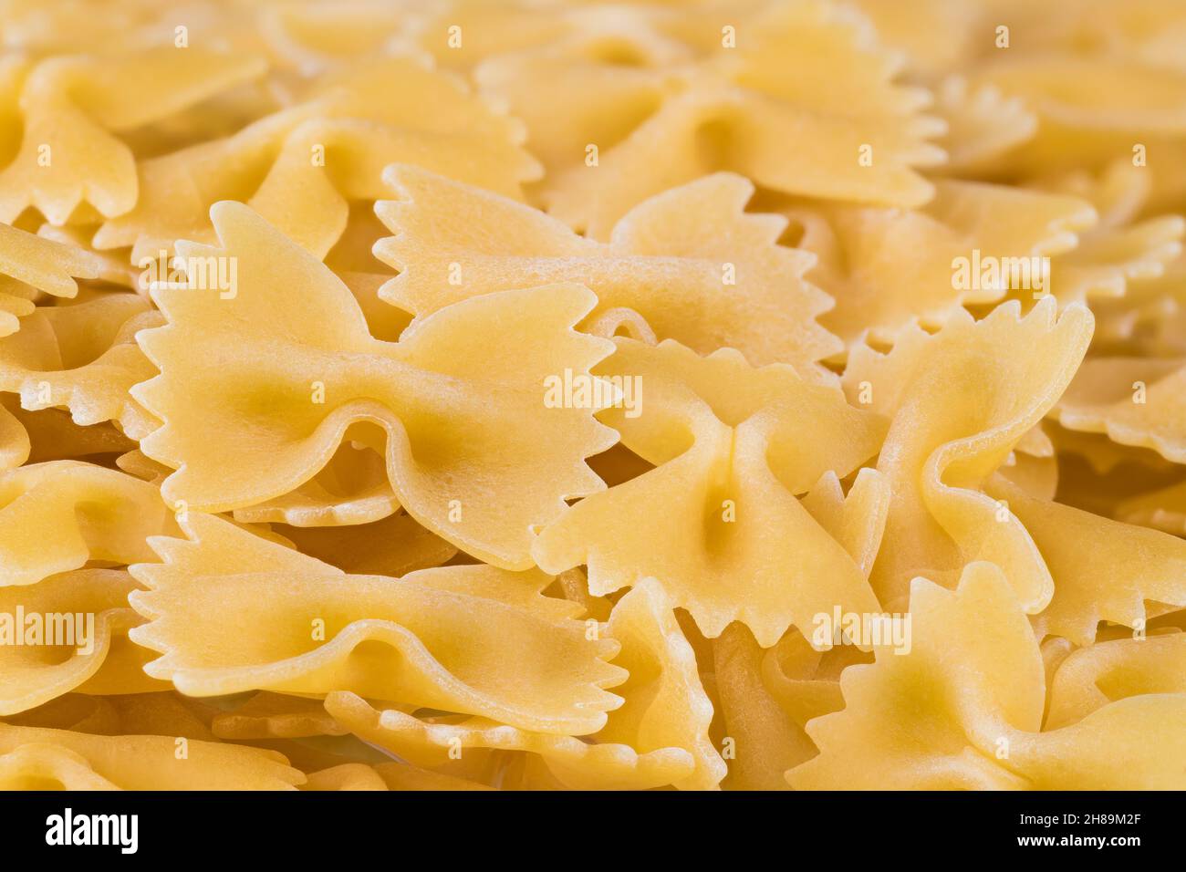 Detail of raw egg butterfly pastas on heap with beautiful blurring in ...
