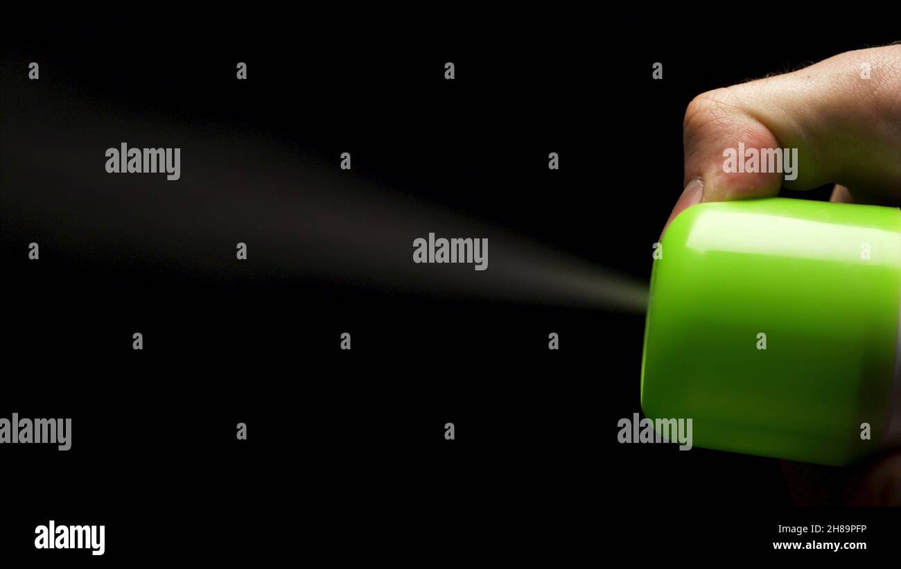 Closeup of spray can spraying aerosol insecticide or fragrance mist ...