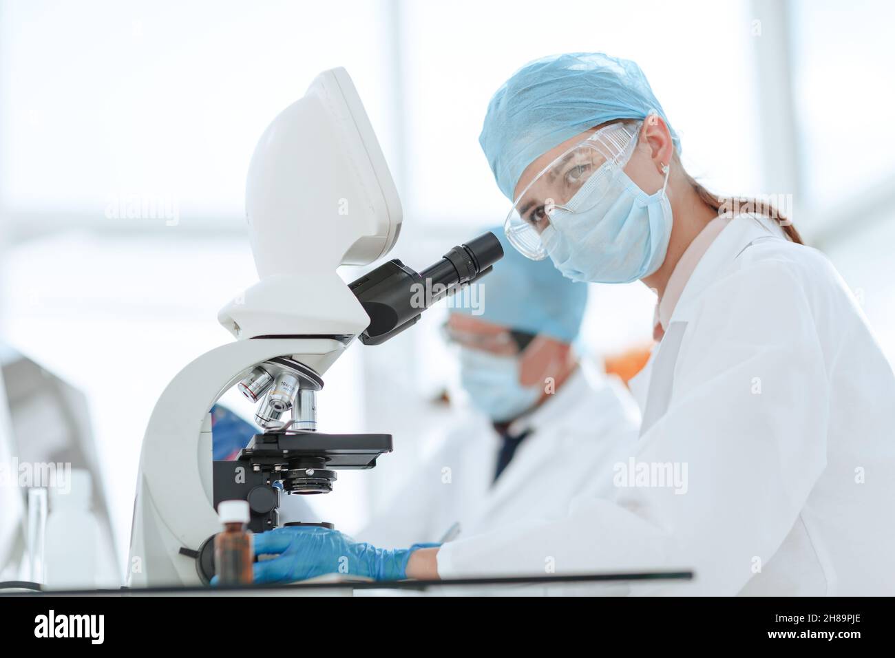 scientists testing the liquid and writing the results in a laboratory ...