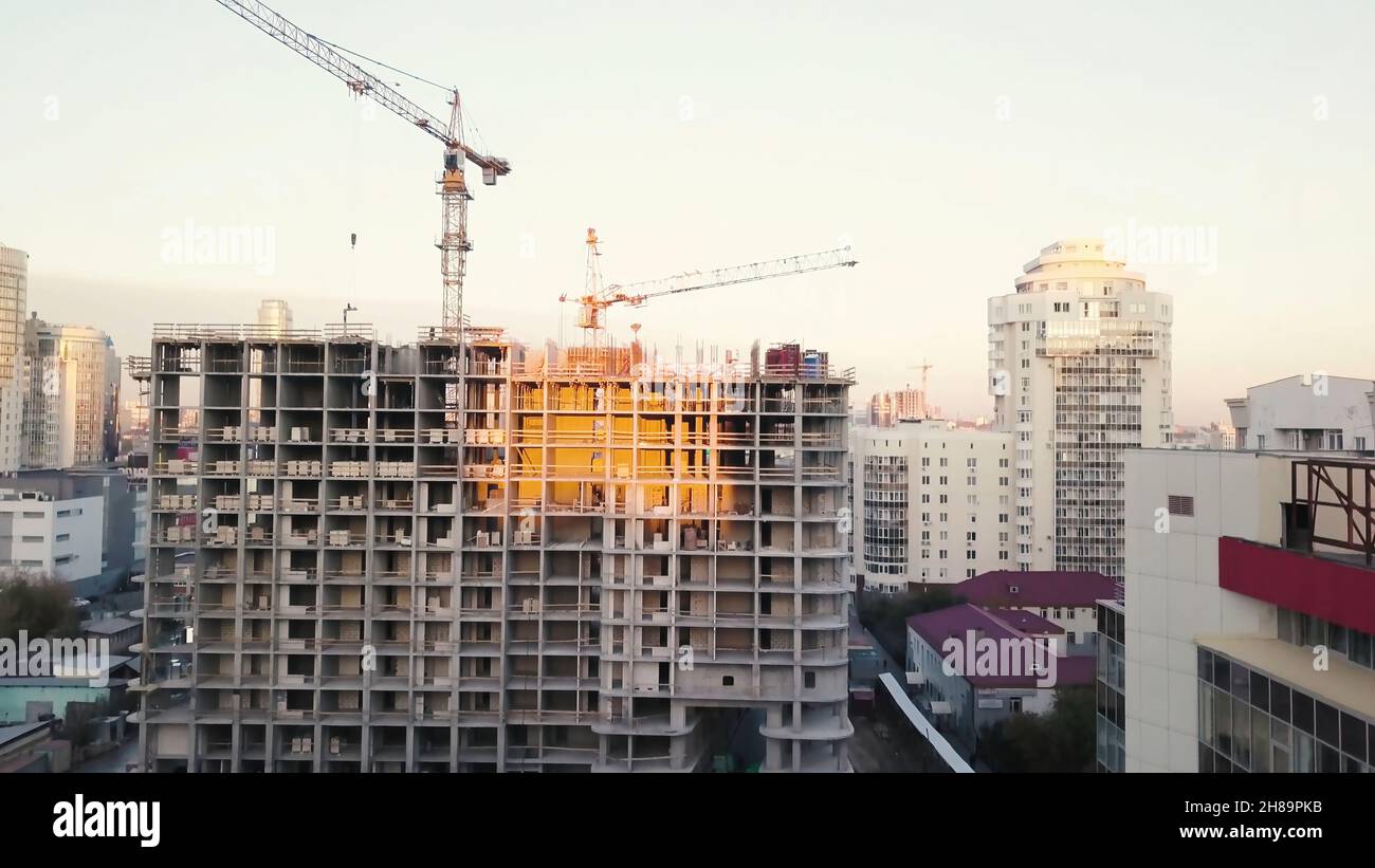 Construction site with cranes. Video. Construction workers are building ...