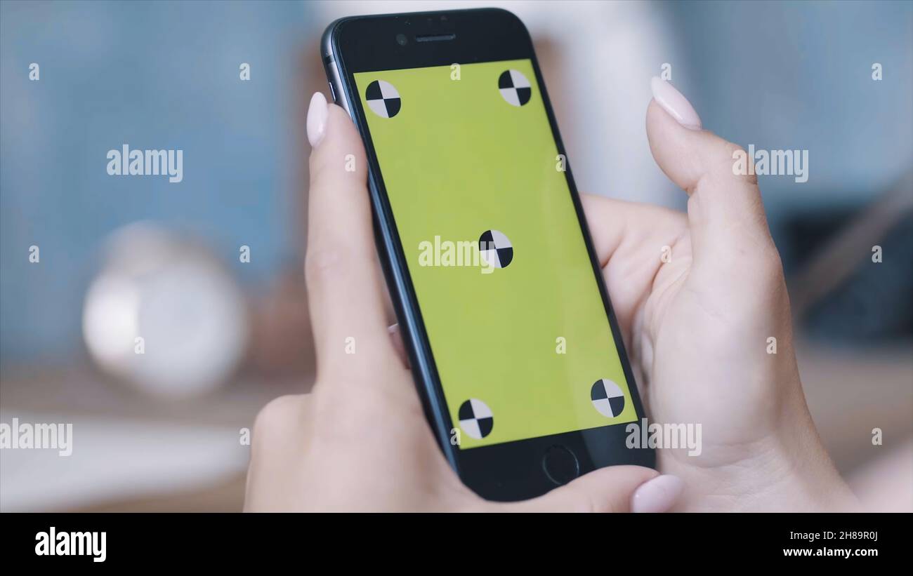 Chroma key screen for placement of your own content. Woman hands with ...