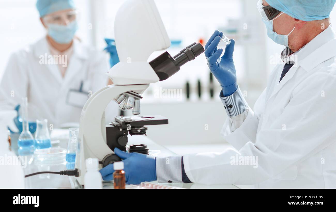 close up. ambitious scientist sitting at a laboratory table Stock Photo ...