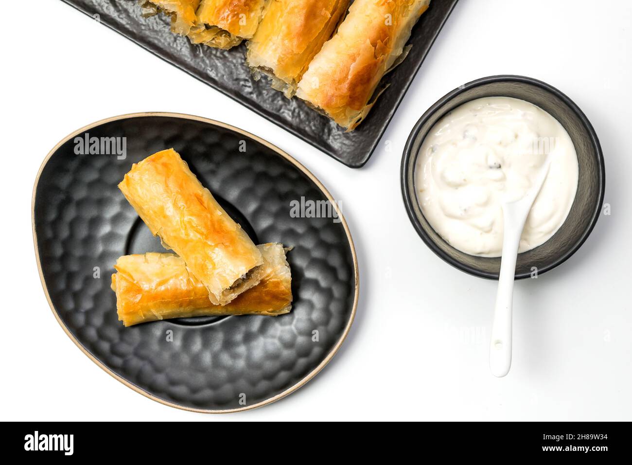 Meat rolls pastry - fried minced pork meat in spring rolls in a black ...