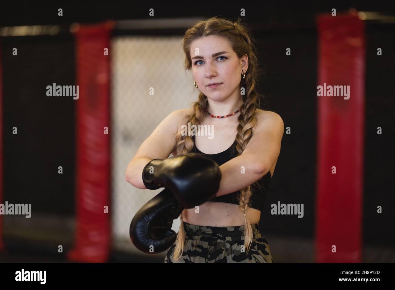 Women's fitness boxing workout in the gym. Young woman with braids ...