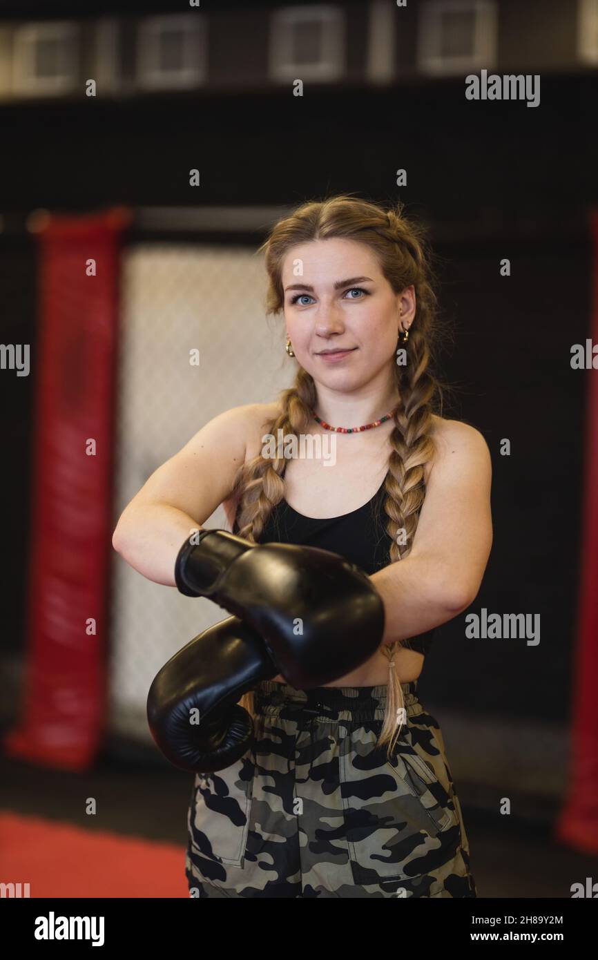 Women's fitness boxing workout in the gym. Young woman with braids ...