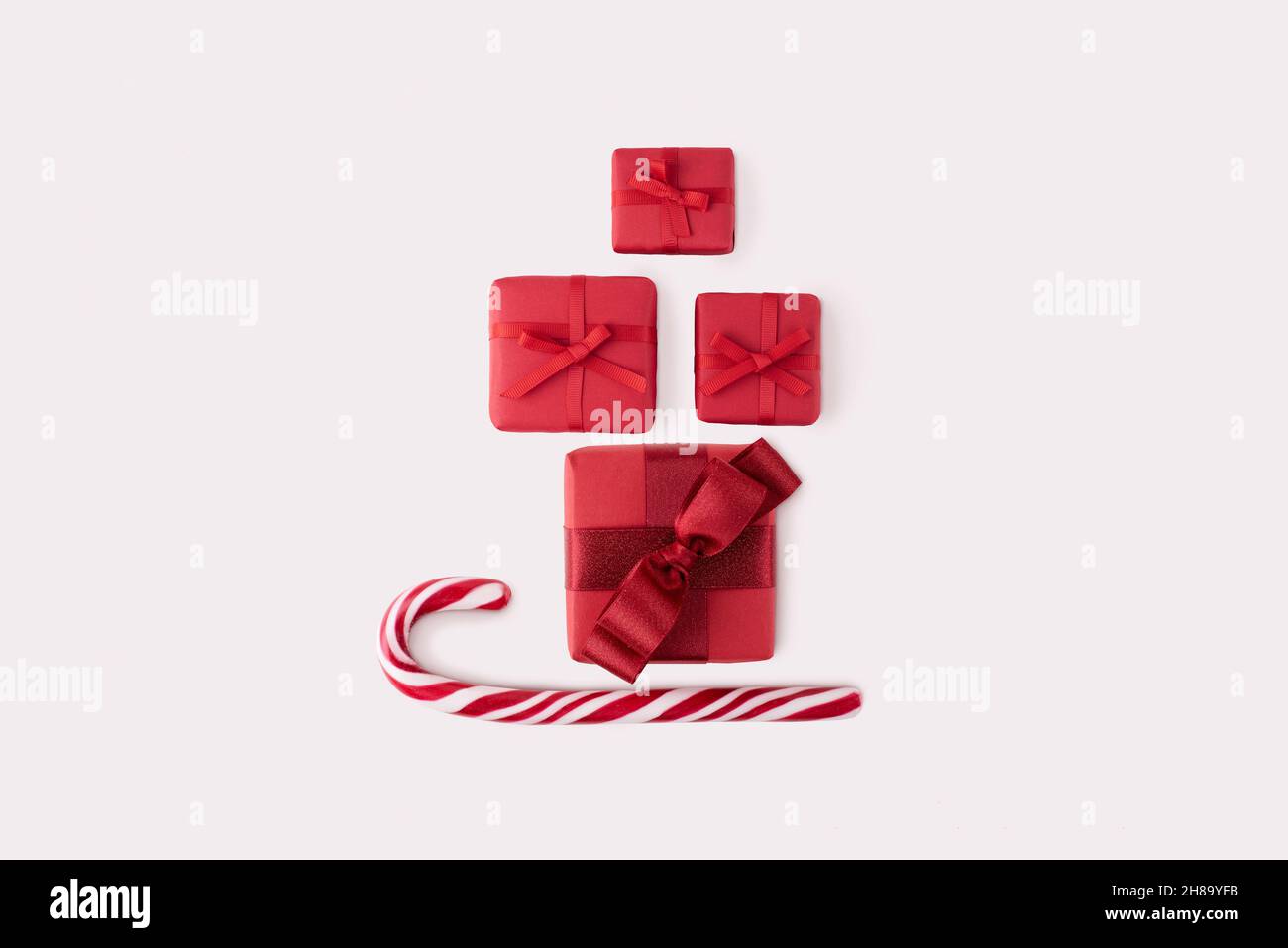 Four red gift and a cane in the form of a sleigh of Santa Claus on ...
