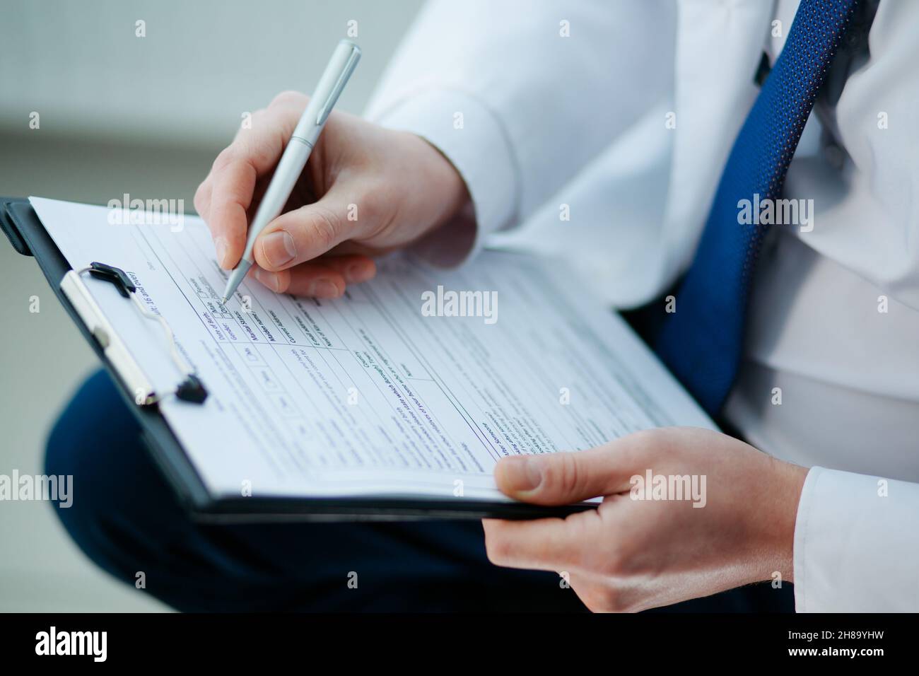 close-up. doctor making notes on the clipboard Stock Photo - Alamy