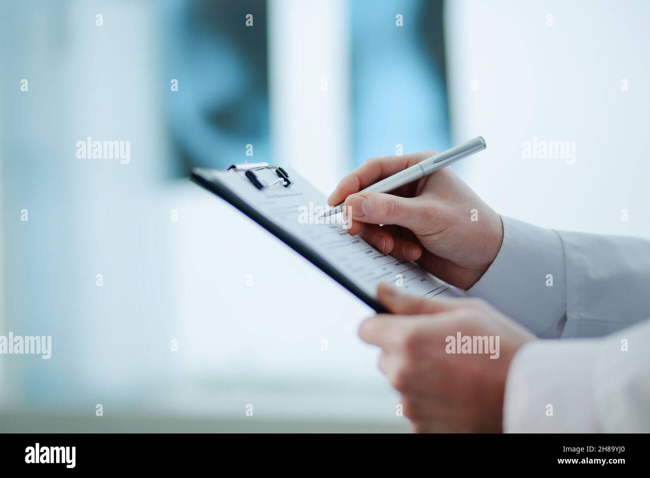 close-up. doctor filling out a medical form Stock Photo - Alamy