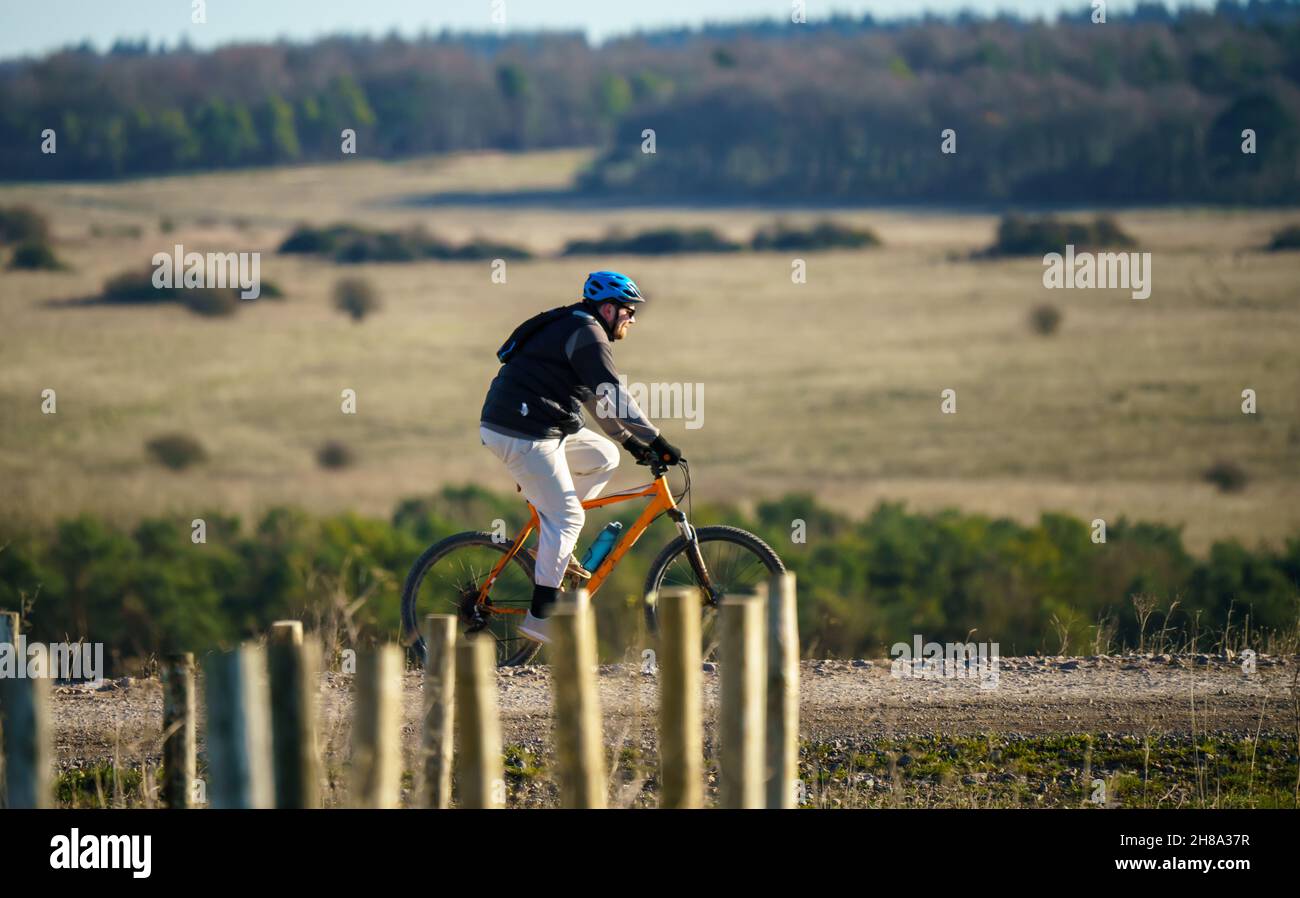 cyclist in high visibility yellow riding along an unmade track on ...