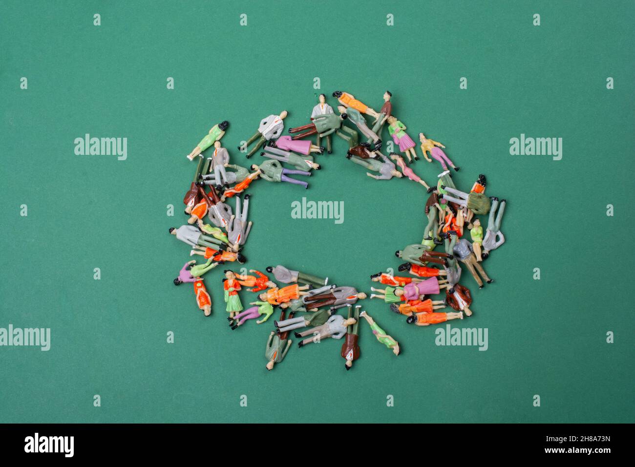 Colorful diverse miniature people figurines make crowd on ground Stock ...