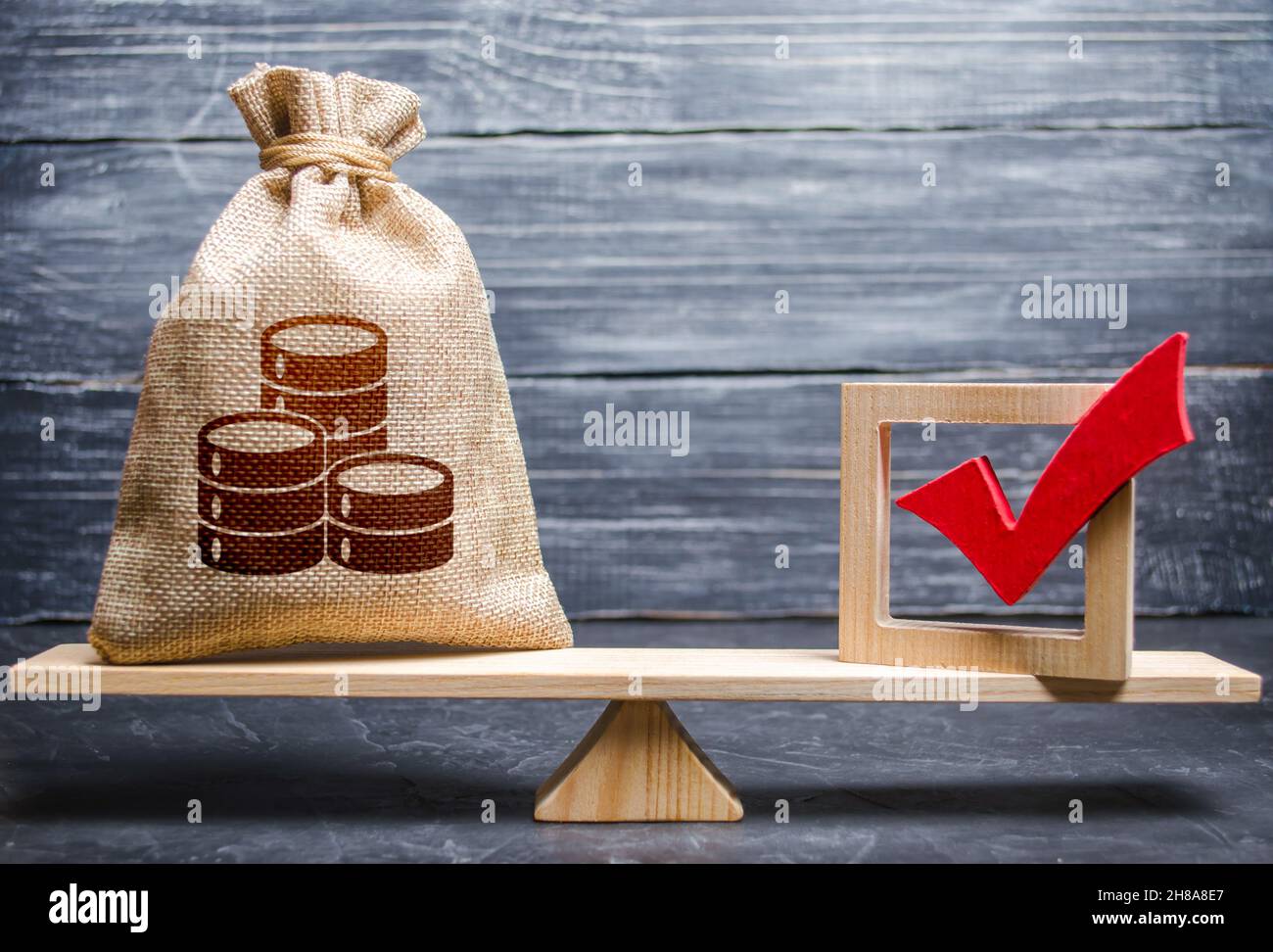 Red vote tick and a money bag on scales. The concept of lobbying for ...