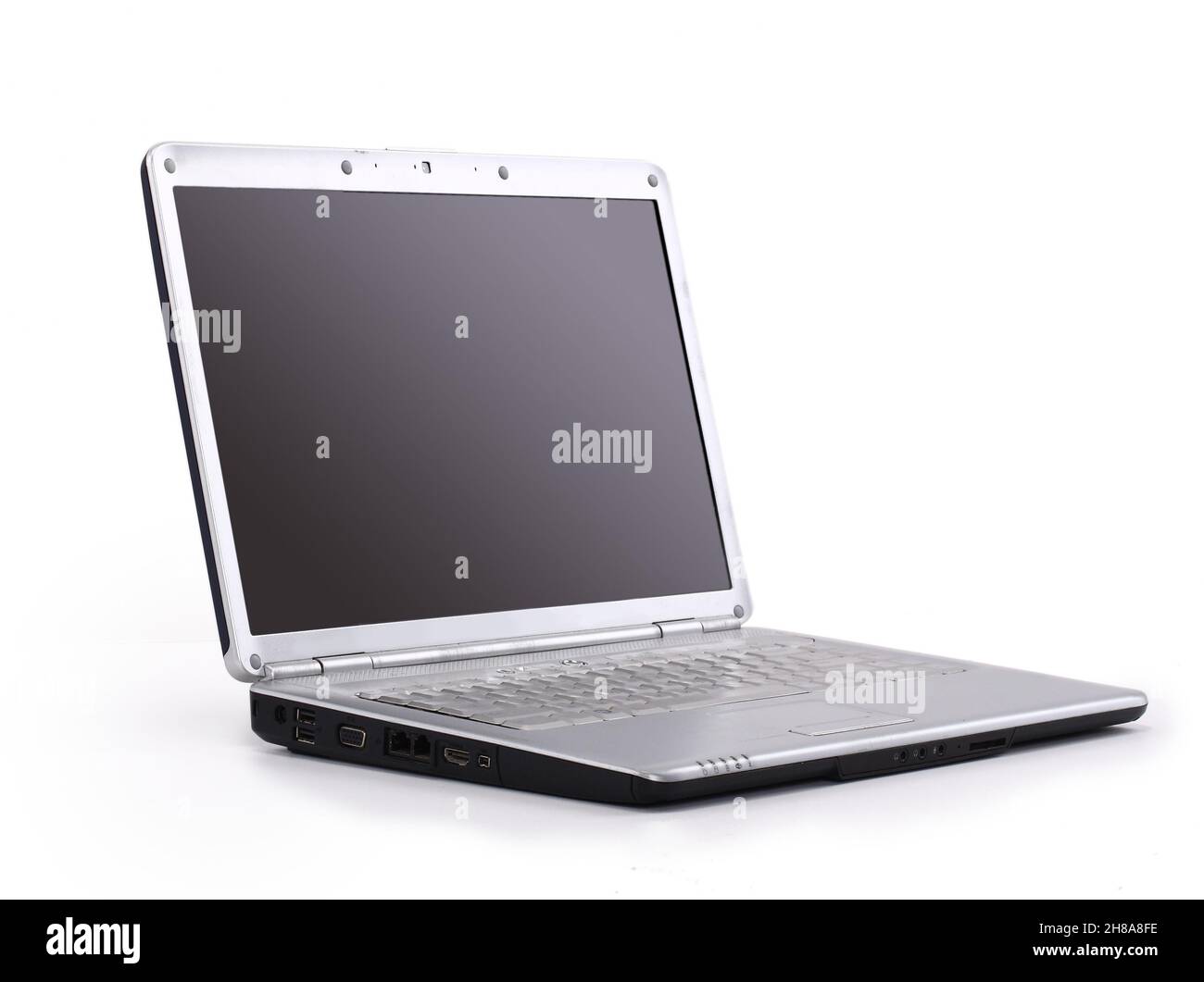 A modern laptop computer and wireless mouse with reflection on a glass ...