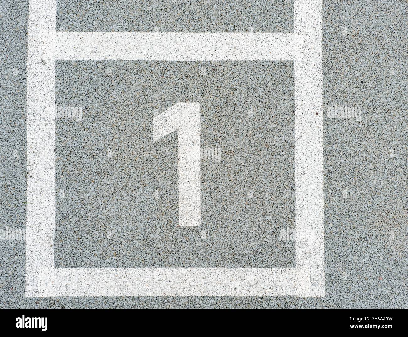 Number one painted on soft rubber surface. Jumping hopscotch game with ...