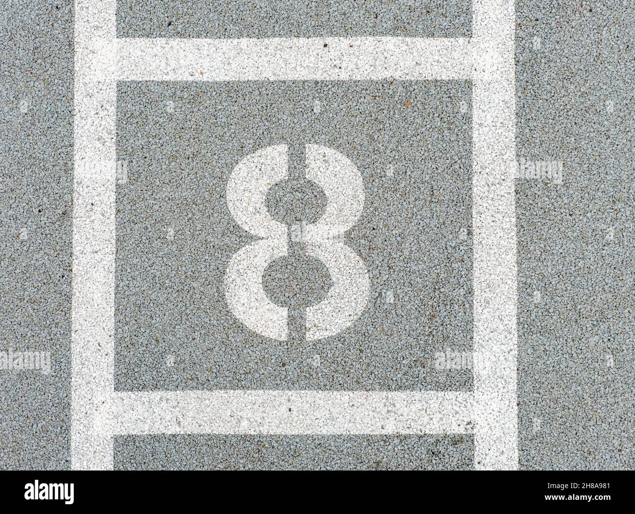 Number eight painted on soft rubber surface. The eighth place. Jumping ...