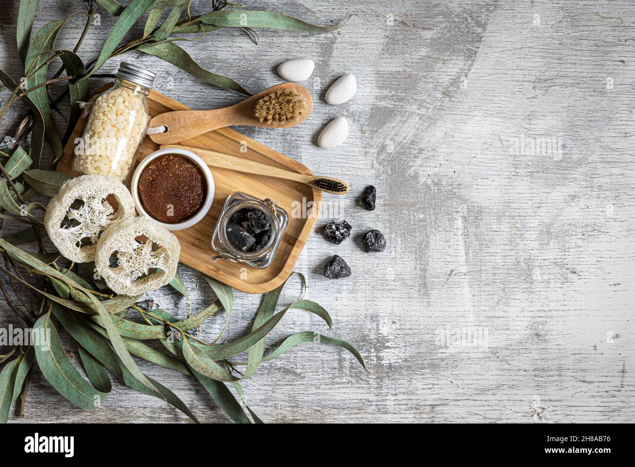 Flat lay spa composition with body products on textured concrete ...