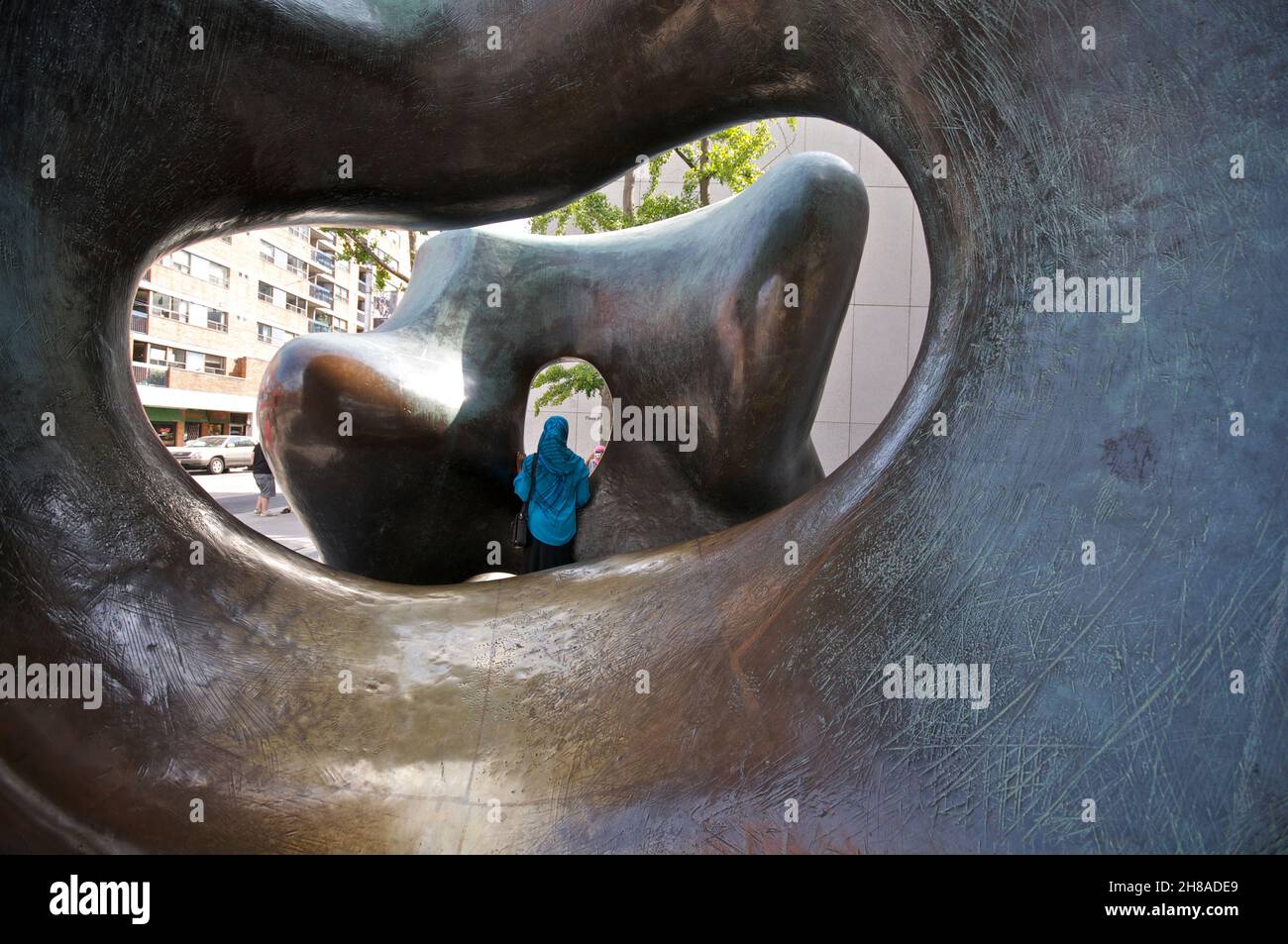 Looking through the sculpture with the rear view of a women in Art ...
