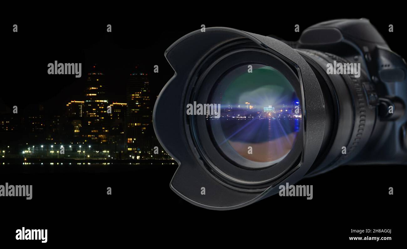 modern DSL camera and telephoto lens with lens hood close up on ...