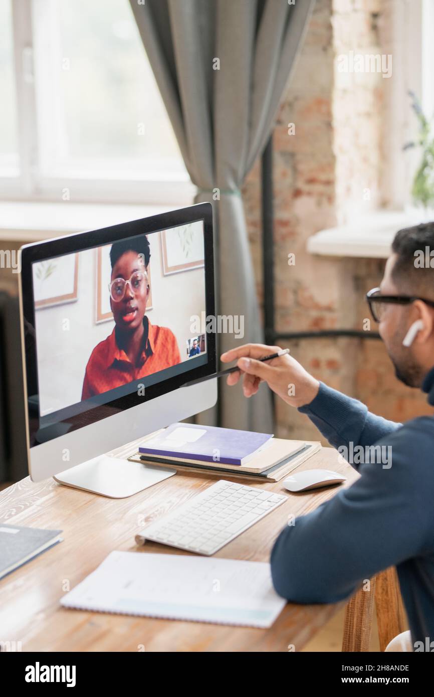 Young confident African woman on computer screen talking to male ...