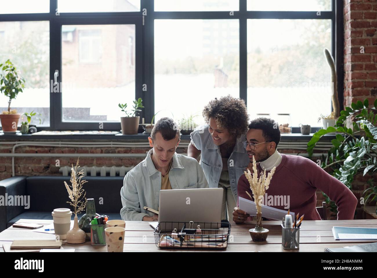 Group of young business people of various ethnicities working over new ...