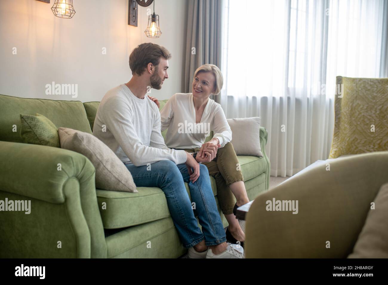 Son visiting his mom and both looking happy Stock Photo - Alamy