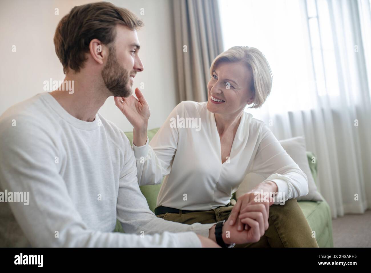Happy mom hugging her son and looking peaceful Stock Photo - Alamy