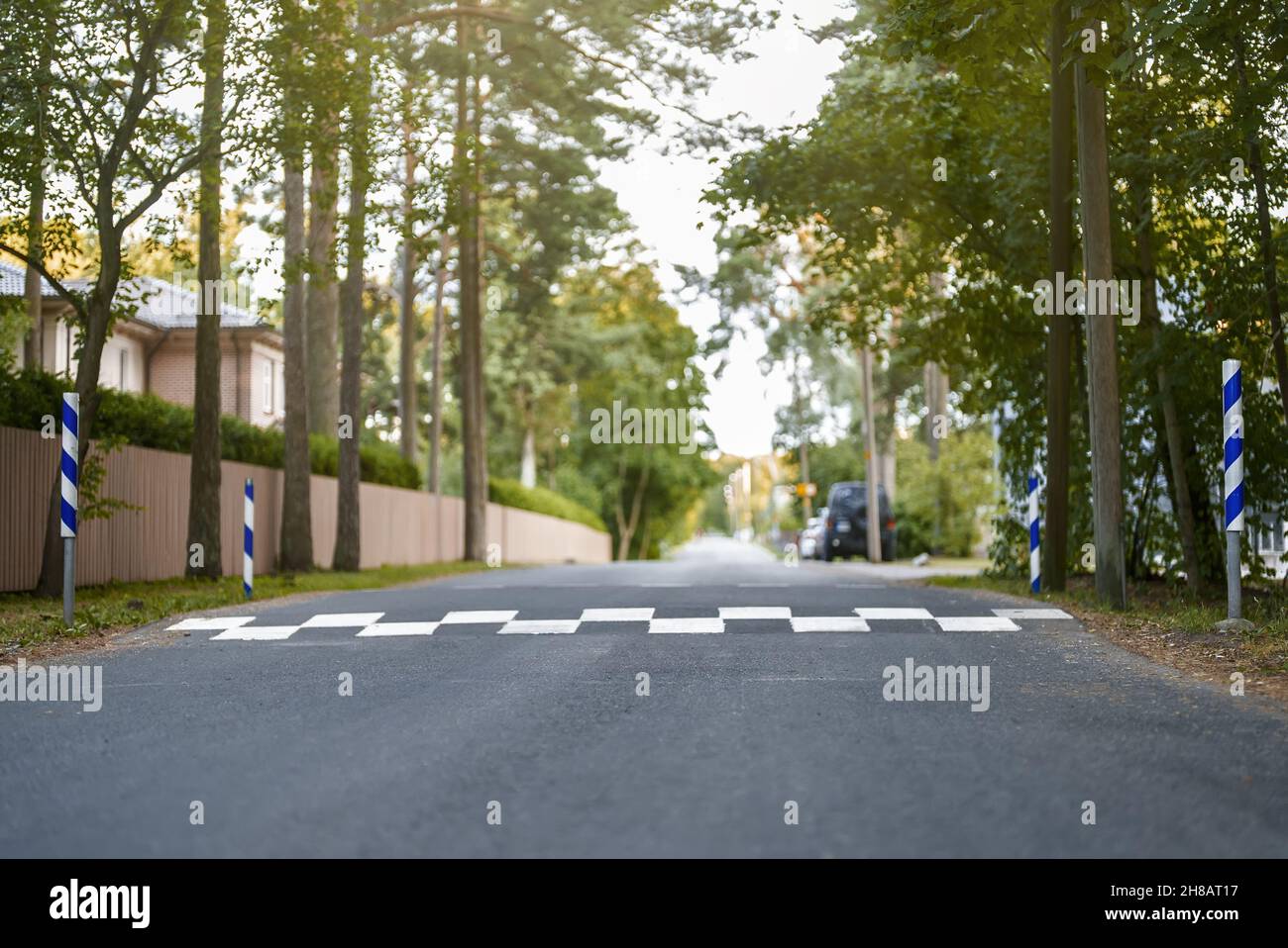 Traffic safety speed bump on asphalt road Stock Photo - Alamy