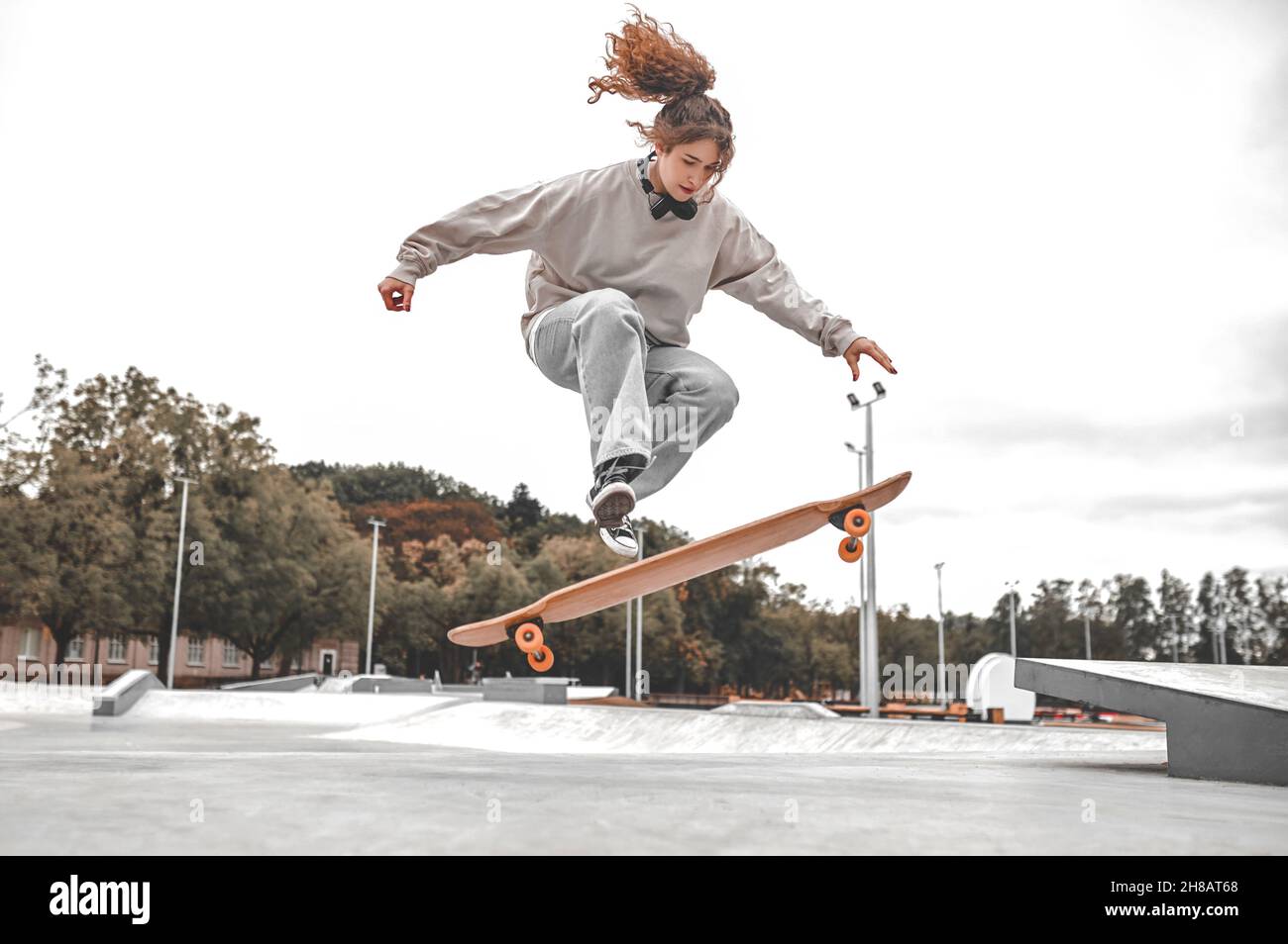 Girl on skateboard jumping up Stock Photo - Alamy