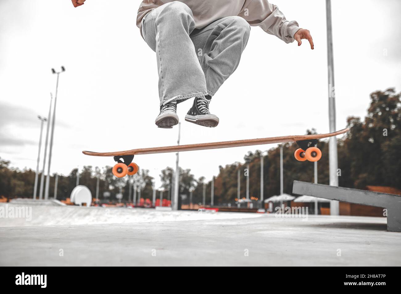 Feet on skateboard while jumping Stock Photo - Alamy