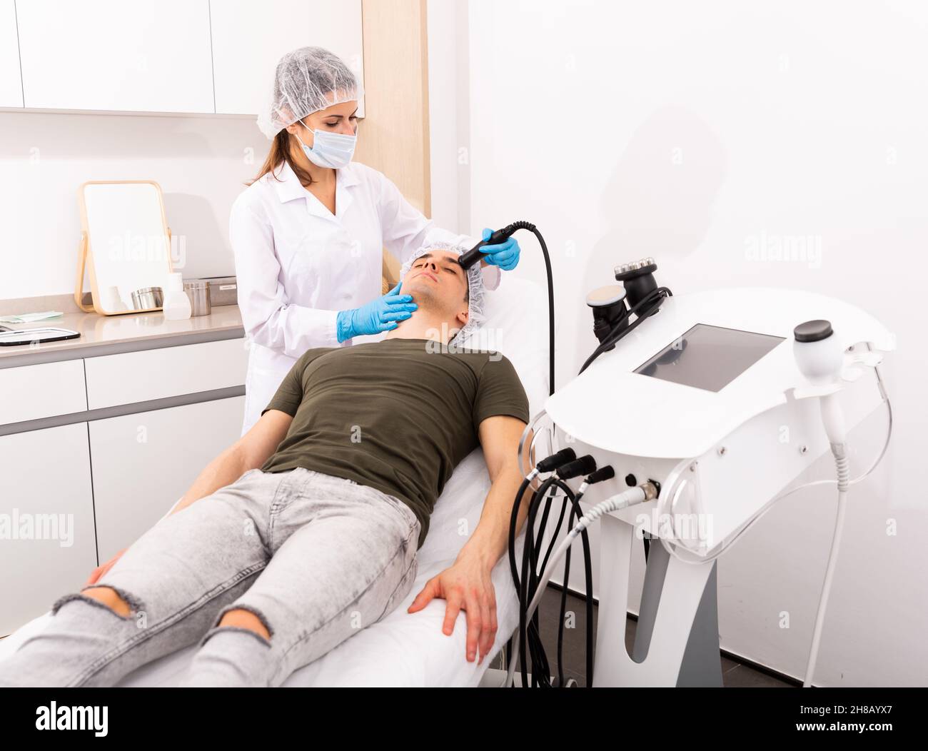 Man getting face ultrasound lifting procedure Stock Photo - Alamy