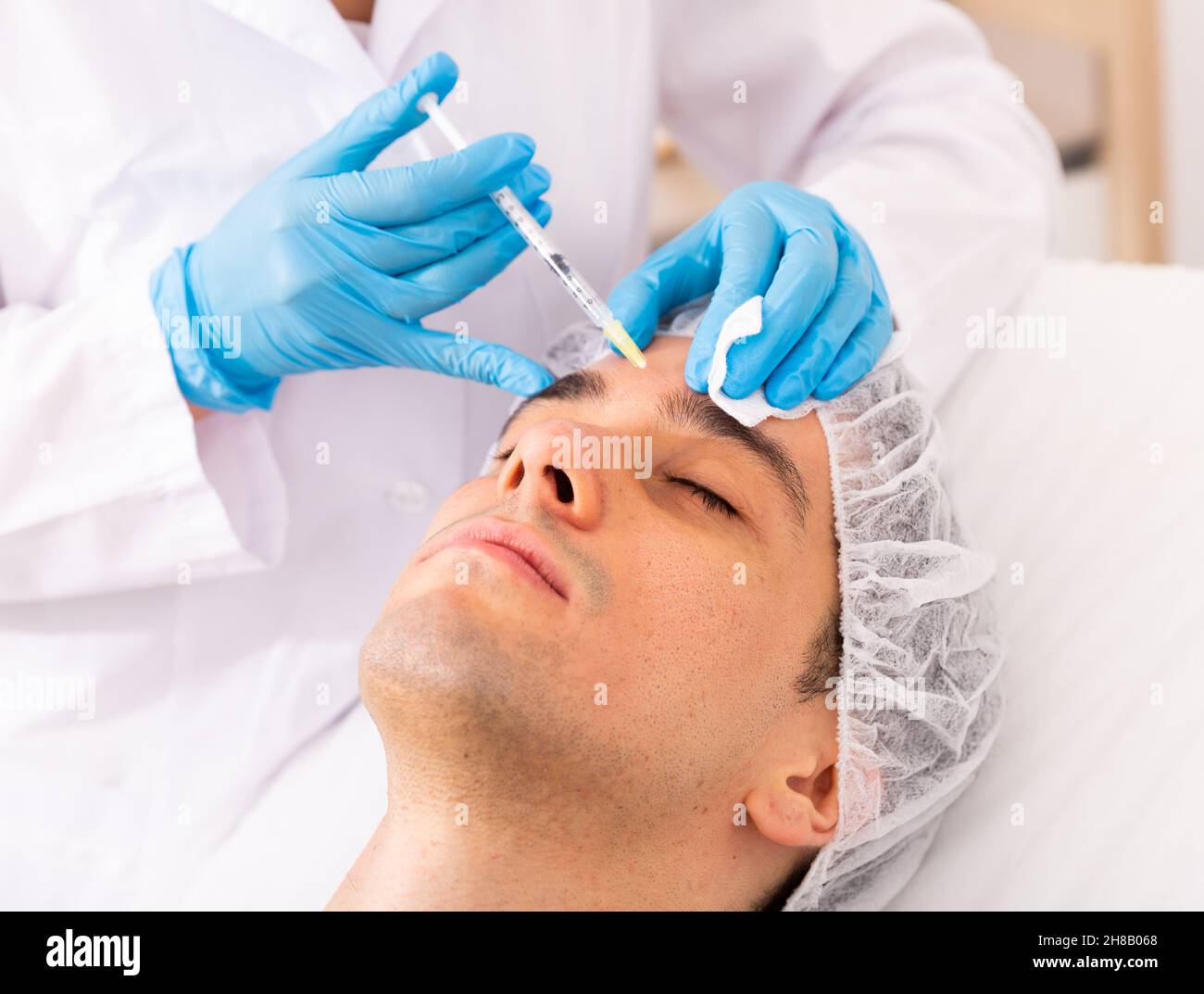 Man getting face injections at aesthetic clinic Stock Photo - Alamy