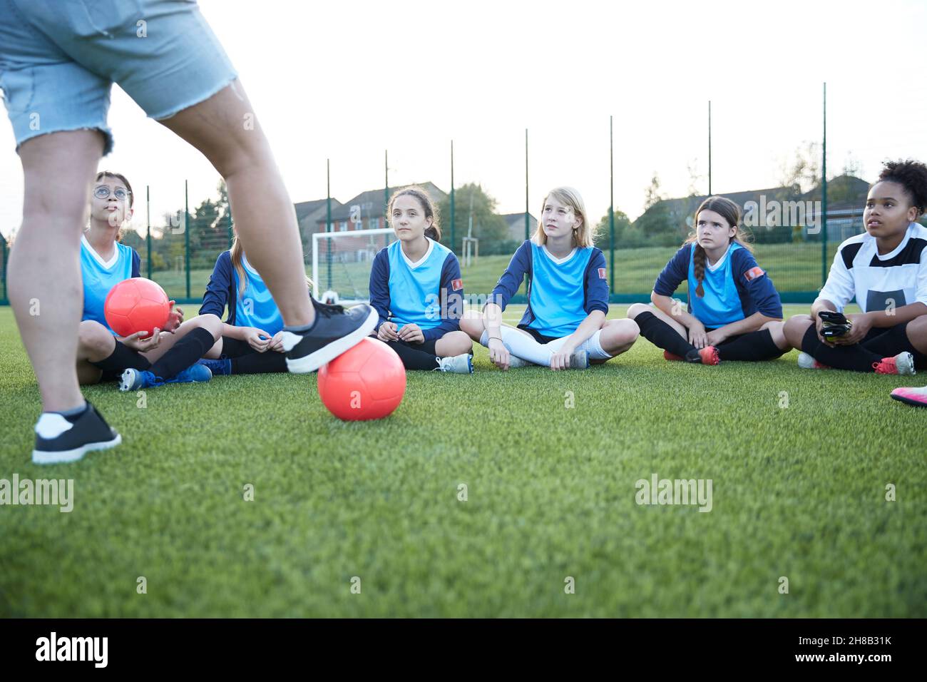 UK, Female soccer team sitting in field during training Stock Photo - Alamy