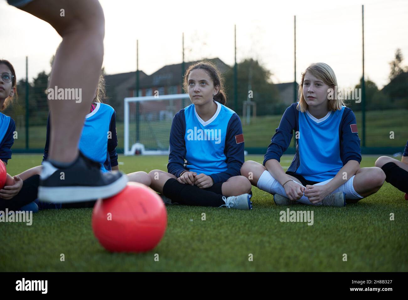 UK, Female soccer team sitting in field during training Stock Photo - Alamy