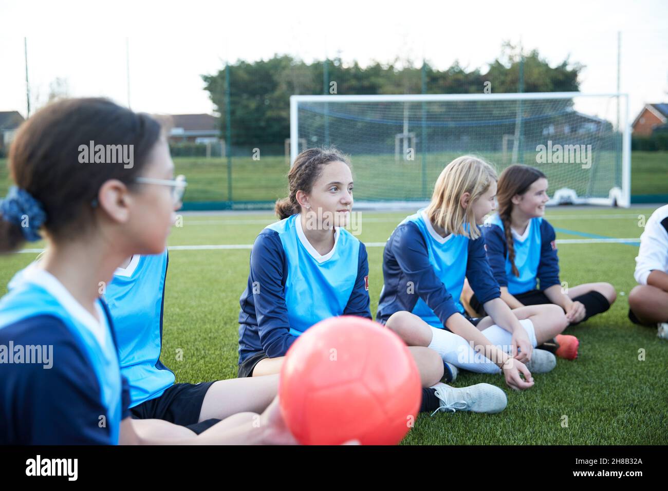 UK, Female soccer team sitting in field during training Stock Photo - Alamy