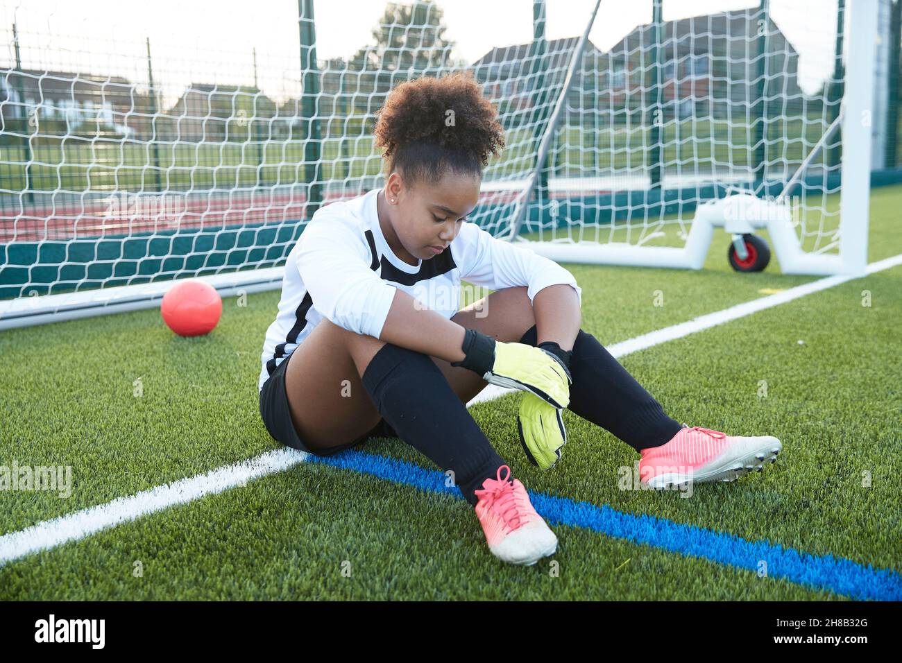 UK, Rear view of female soccer goalie defending goal Stock Photo - Alamy