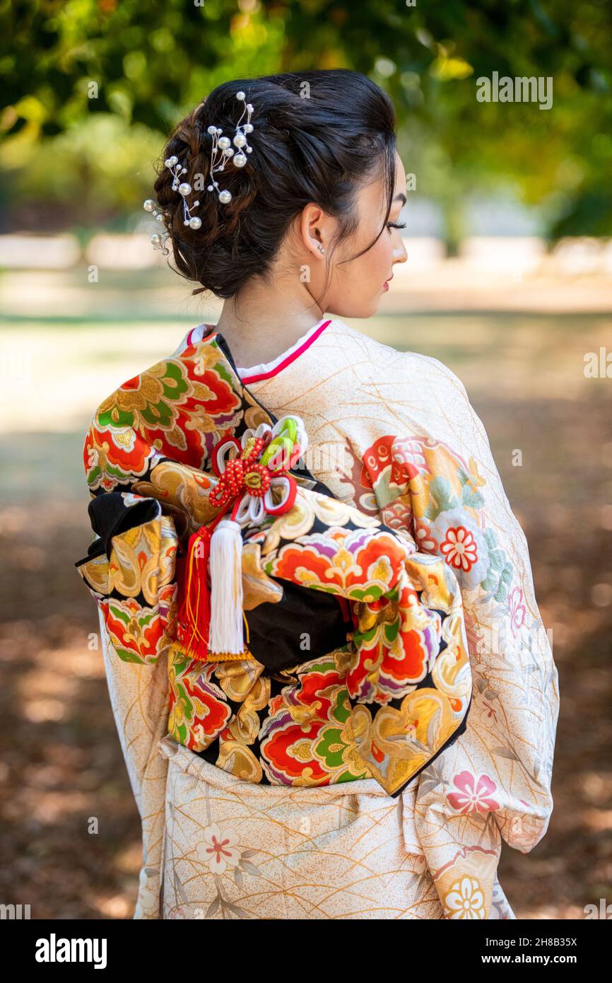 Rear view of woman wearing kimono standing in park Stock Photo - Alamy