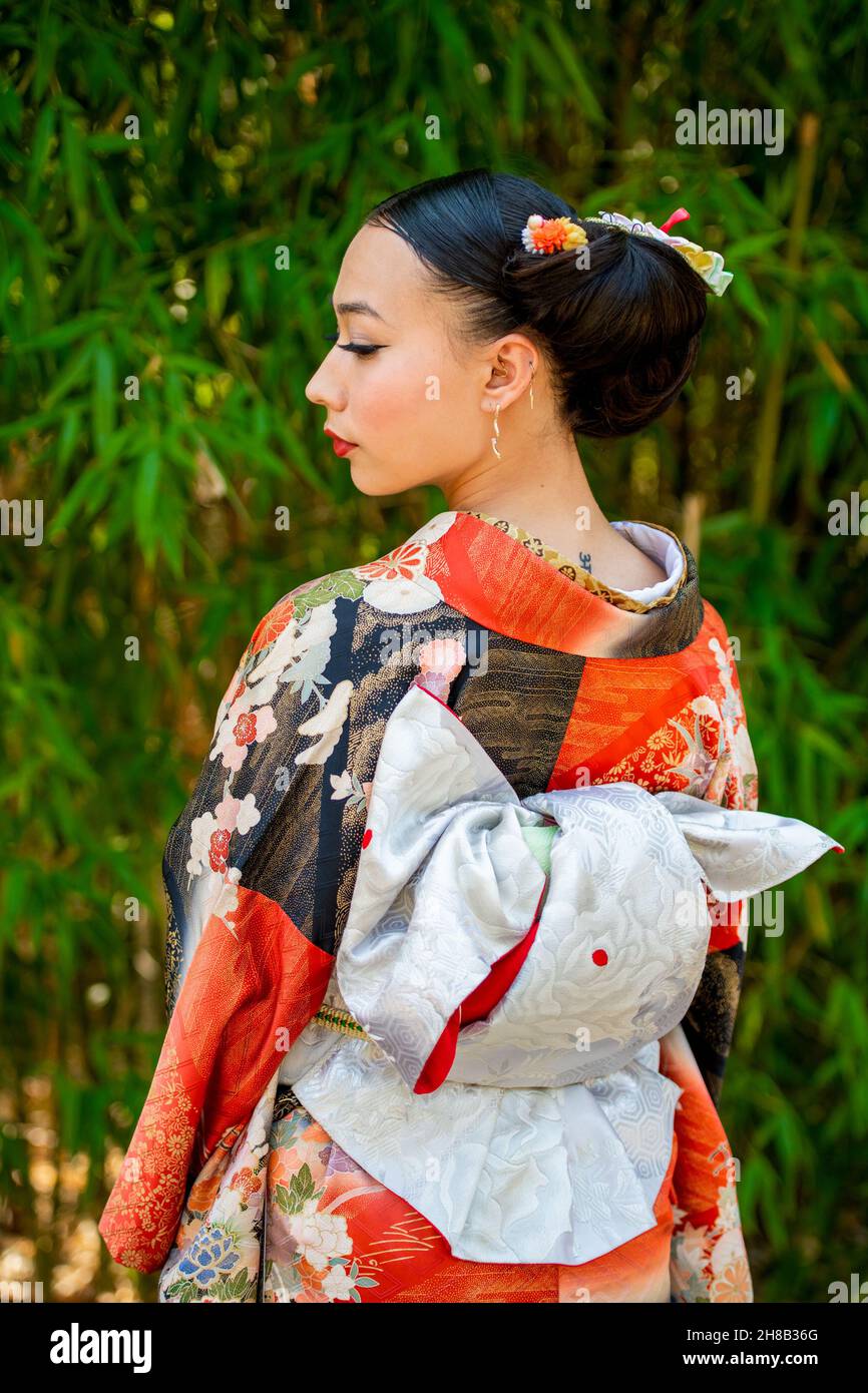 Rear view of woman wearing kimono standing in park Stock Photo - Alamy