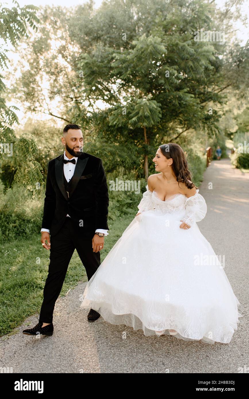 Bride walking groom in park hi-res stock photography and images - Alamy