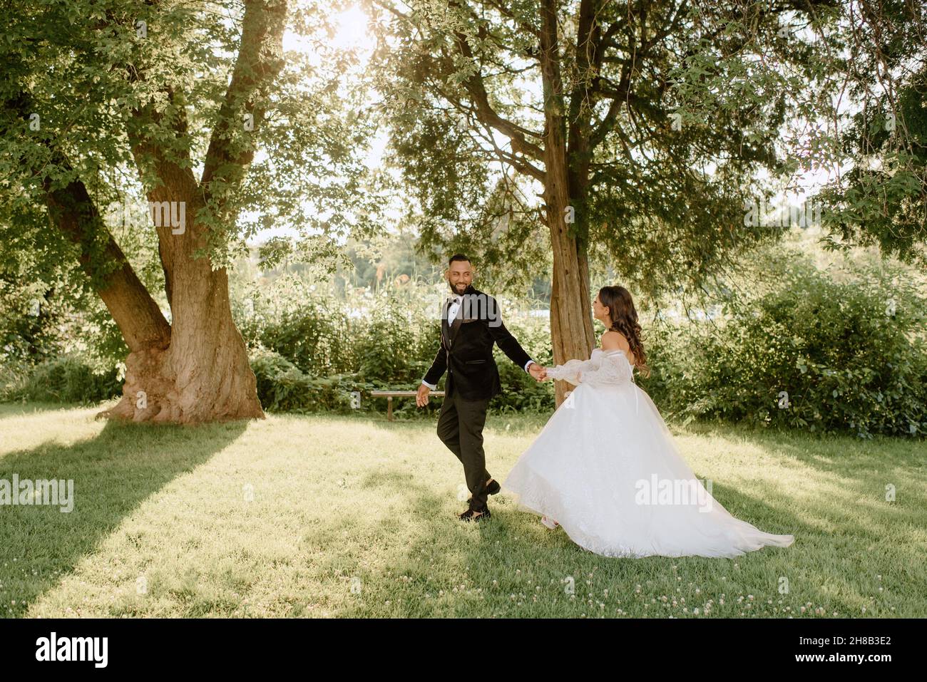 Bride walking groom in park hi-res stock photography and images - Alamy