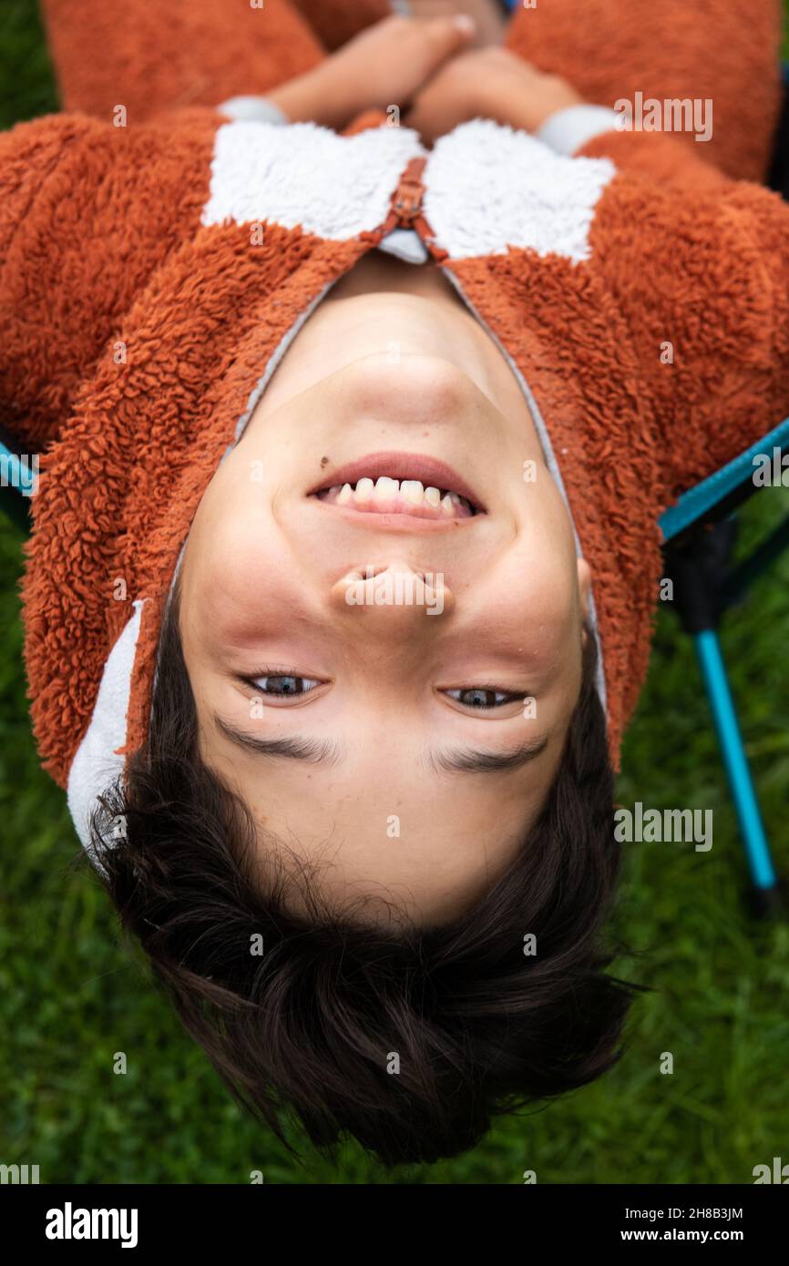 Portrait of boy (10-11) bending over backwards Stock Photo - Alamy