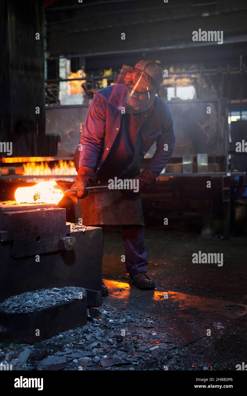 Worker pre forms steel billet on 5 tonne clear space hammer before it ...
